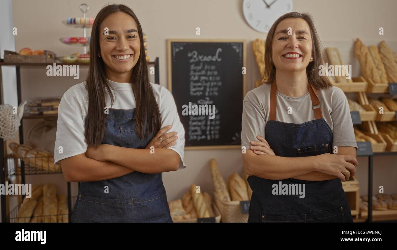 Two women bakers with crossed arms smile confidently in a cozy bakery ...