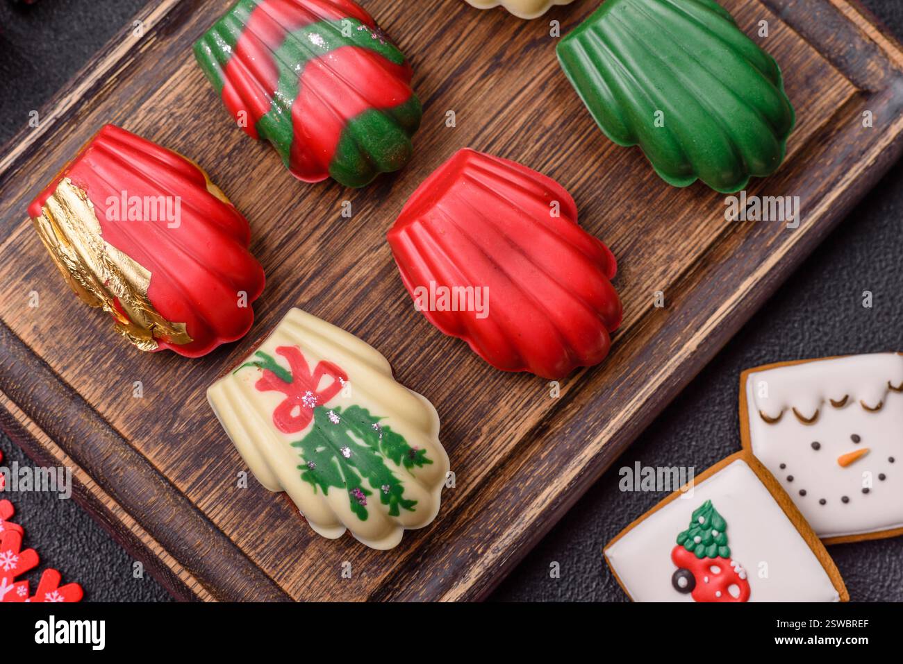 Sweet madeleine sponge cookies covered with colored chocolate Stock ...