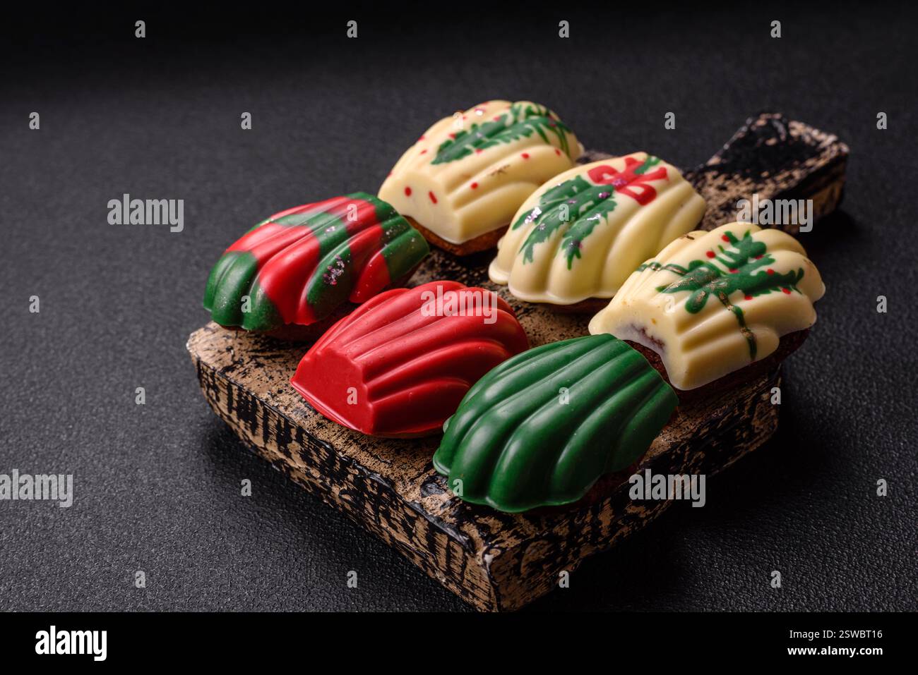 Sweet madeleine sponge cookies covered with colored chocolate Stock ...