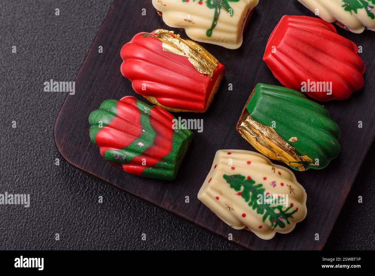 Sweet madeleine sponge cookies covered with colored chocolate Stock ...