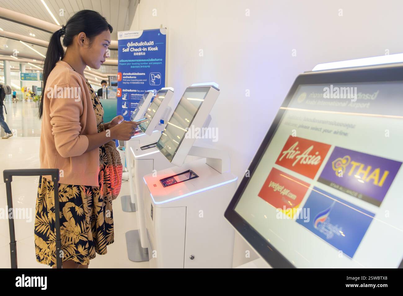 KRABI, THAILAND, DEC 03 2024, Young woman using self check-in kiosks in ...