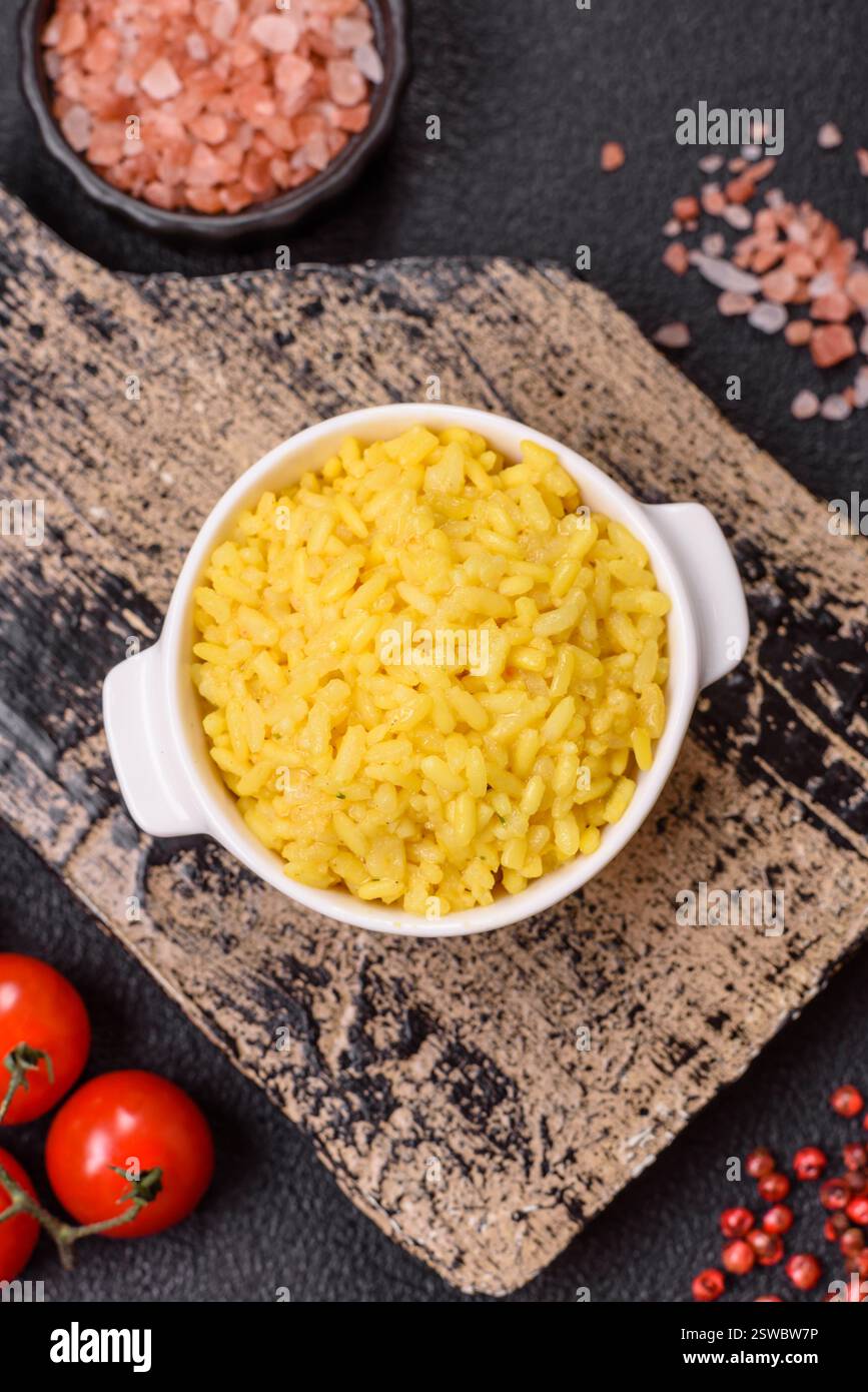 Italian arborio risotto rice with salt, spices and herbs on a dark ...