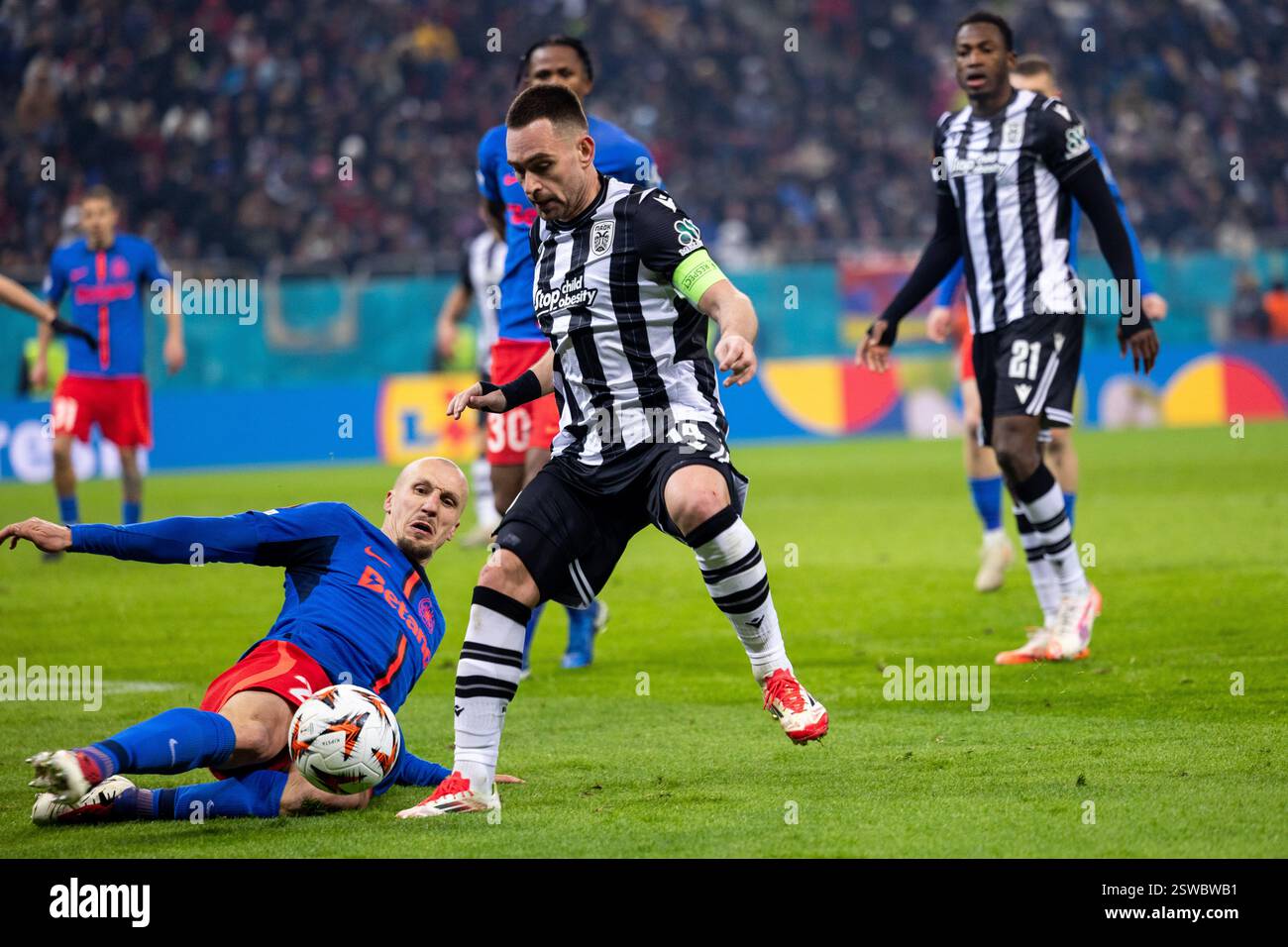 Vlad Chiriches of FCSB tackling Andrija Zivkovic of PAOK FC during the ...