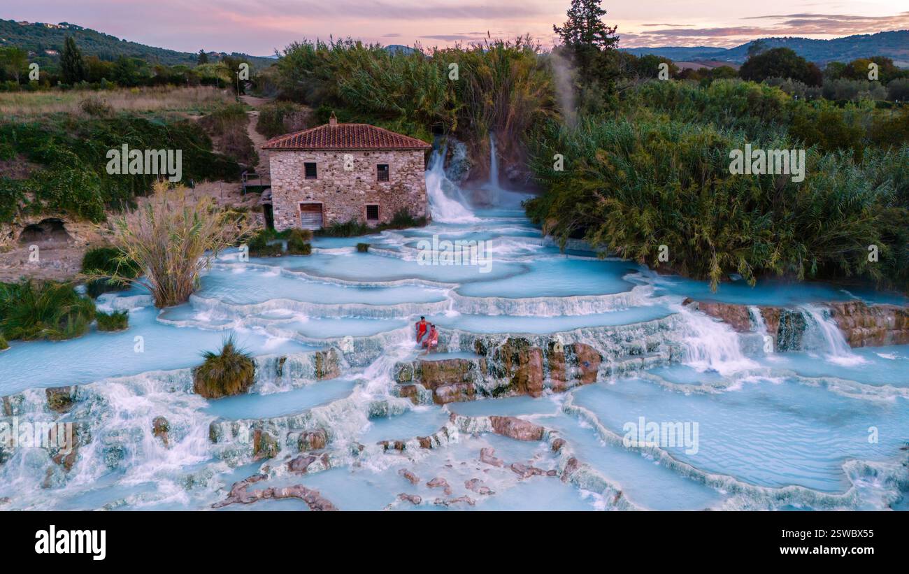 Relaxing in the natural thermal pools of Saturnia, Tuscany at sunset ...