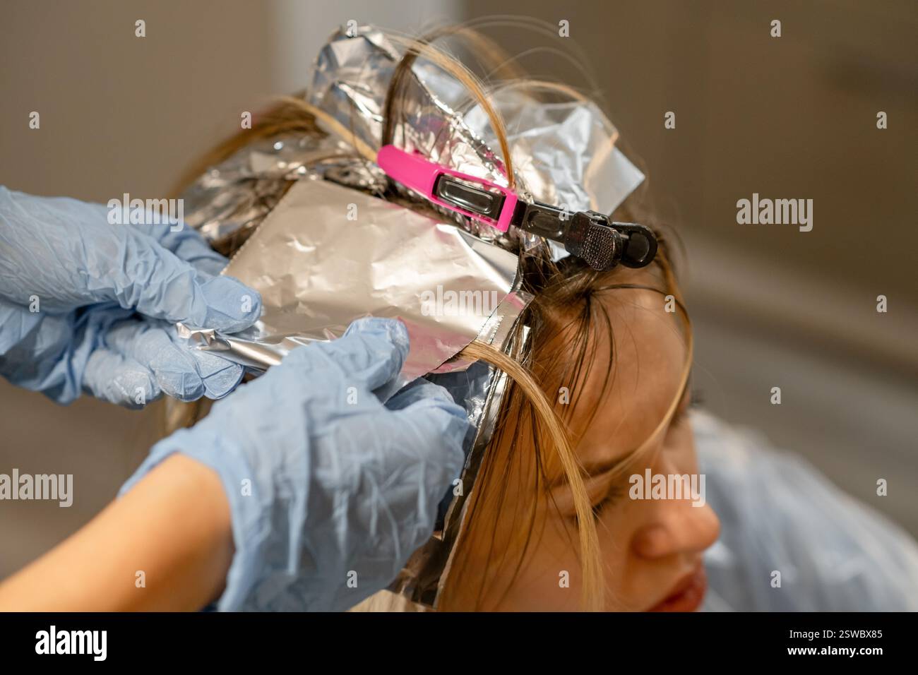 Hair coloring process with highlights in a modern salon setting during ...