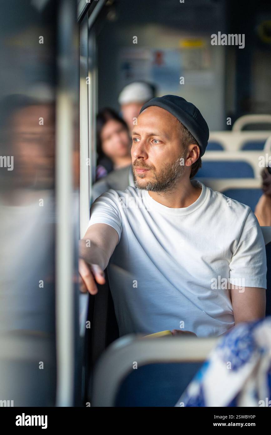 Man deep in thought gazing outside train window, thinking, work life ...