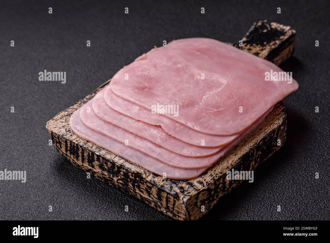 Boiled ham cut into square slices with sorrel and spices Stock Photo ...