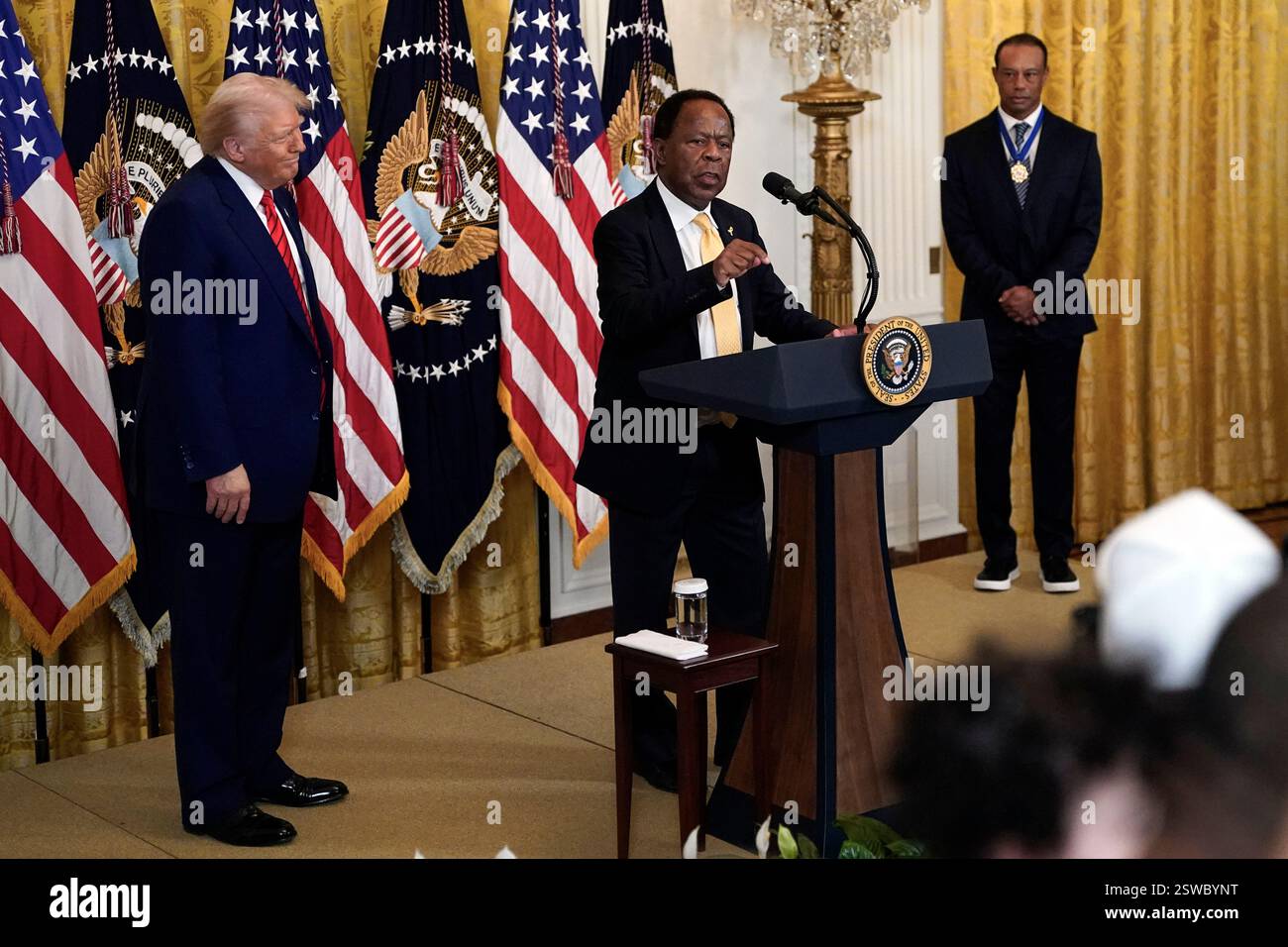 President Donald listens as Leo Terrell speaks during a reception for ...