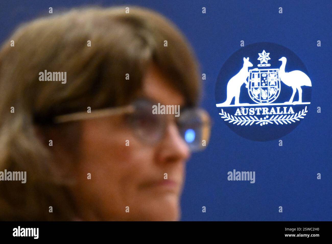 The Australian Coat of Arms is seen behind Governor of the Reserve Bank ...