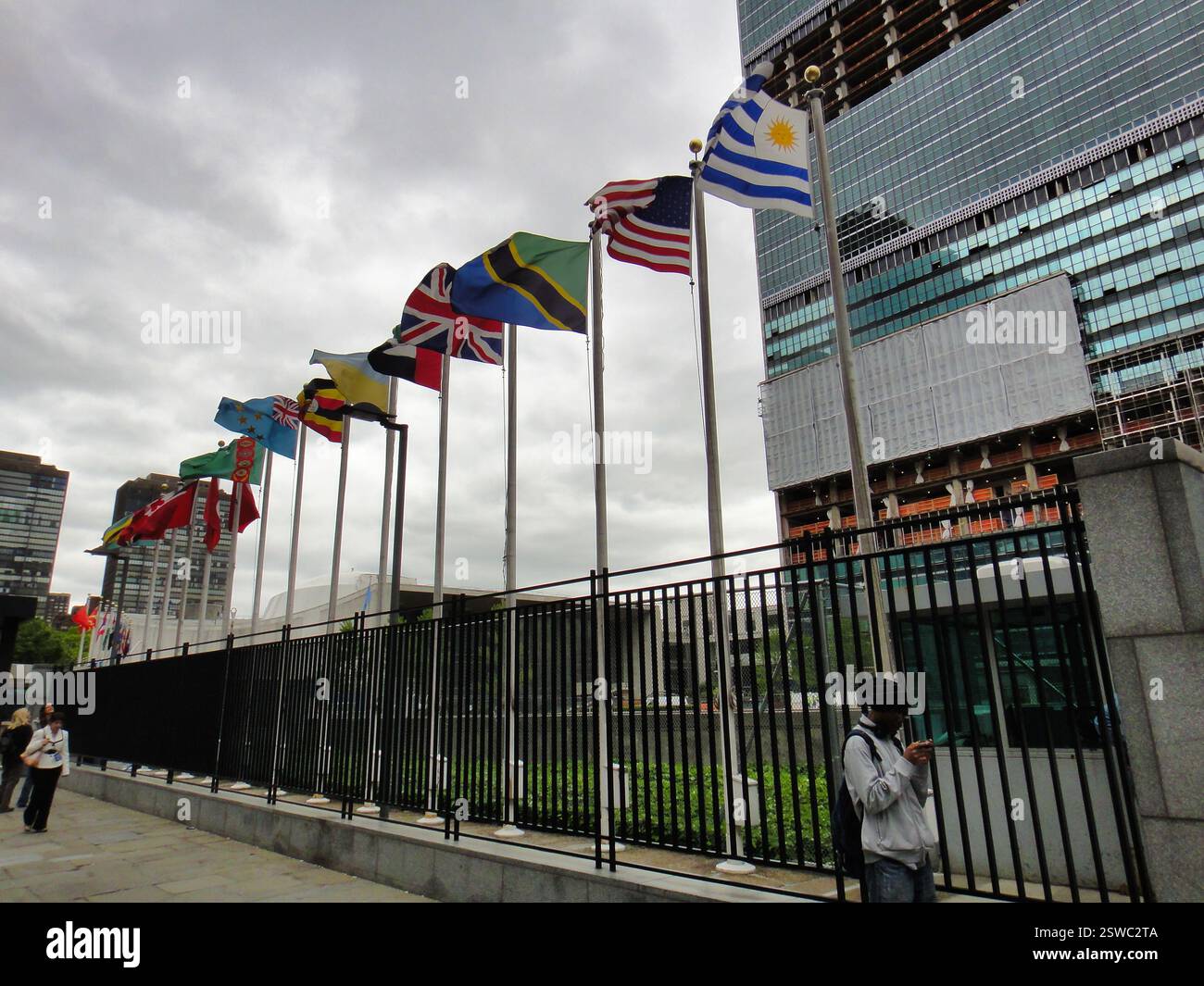 A row of flags, including the Flag of the United States, is proudly ...