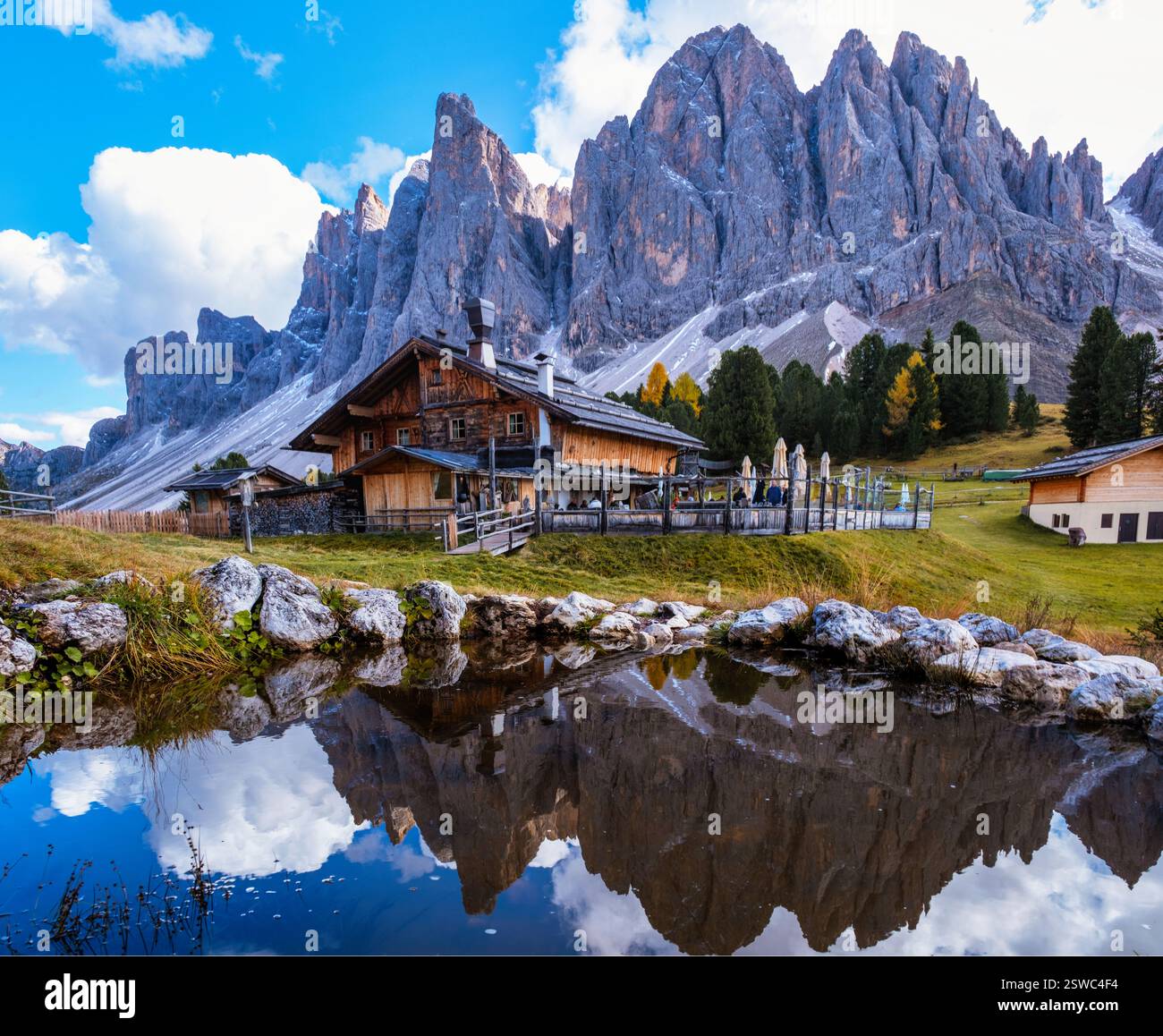 Discover the serene charm of a rustic cabin nestled by the Dolomites ...