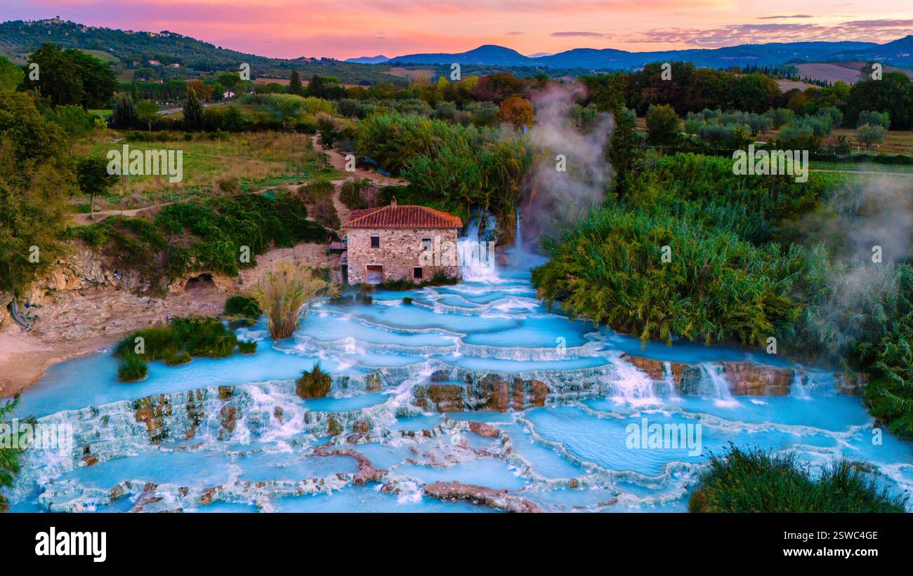 Relaxing in the natural thermal pools of Saturnia, Tuscany, at sunset ...