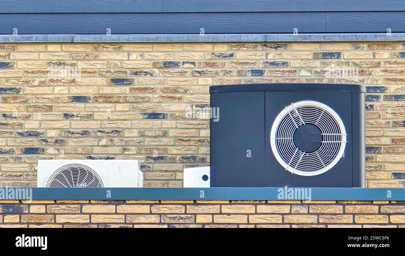 Air source heat pump unit installed outdoors at a modern home with ...