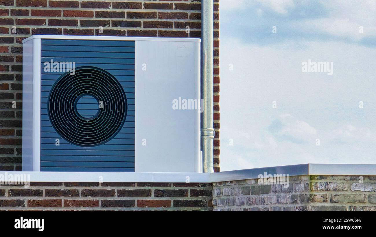 Air source heat pump unit installed outdoors at a modern home with ...
