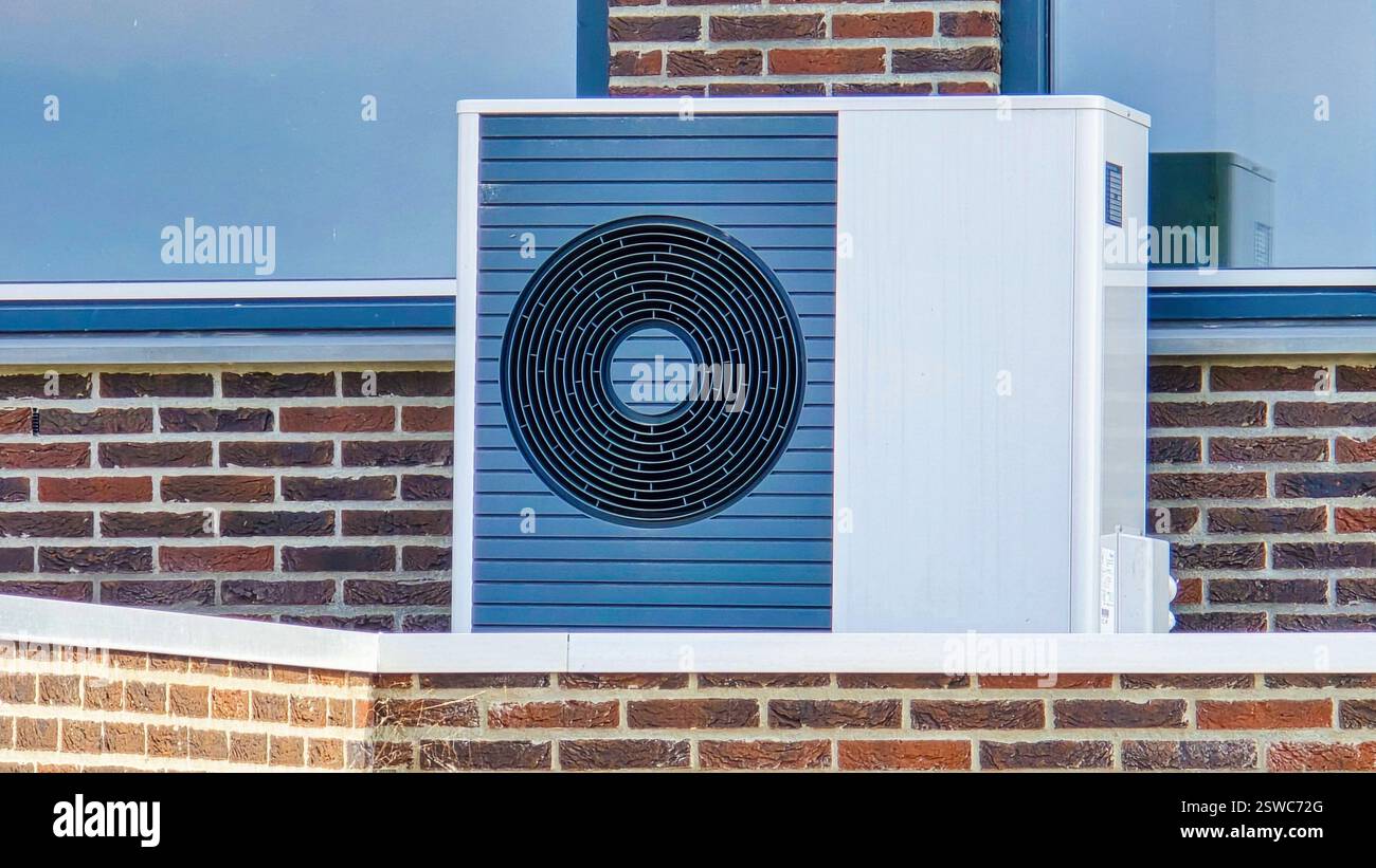 Air source heat pump unit installed outdoors at a modern home with ...