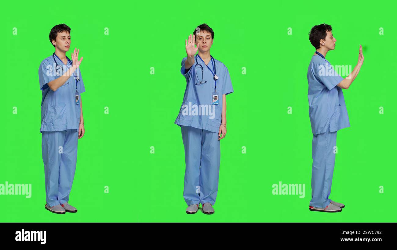 Health specialist with blue scrubs showing stop sign in studio ...