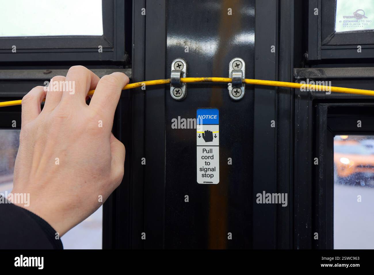 A person pulls a signal stop pull cord in a New York City transit bus ...