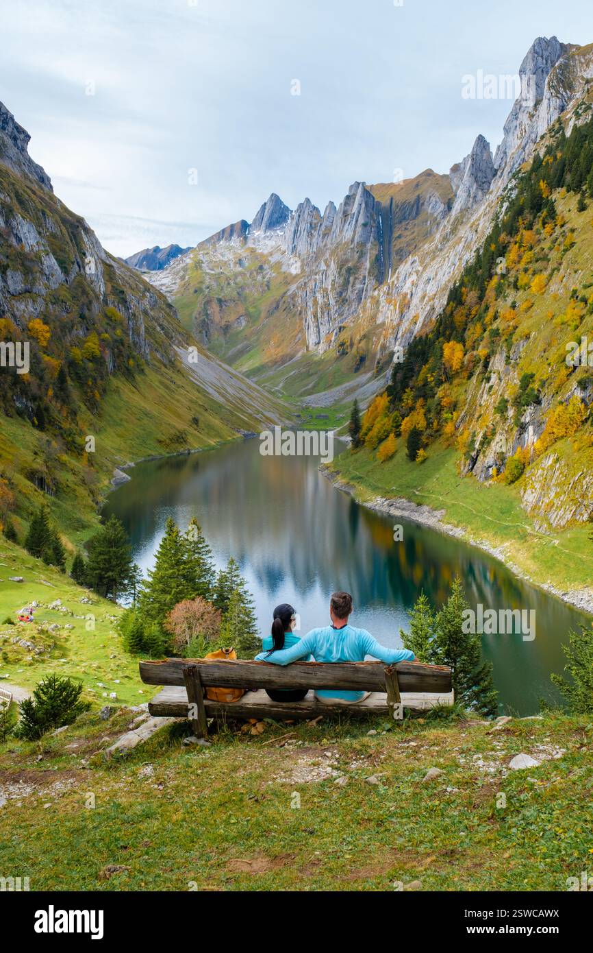 A serene moment unfolds as two individuals sit on a bench by the ...
