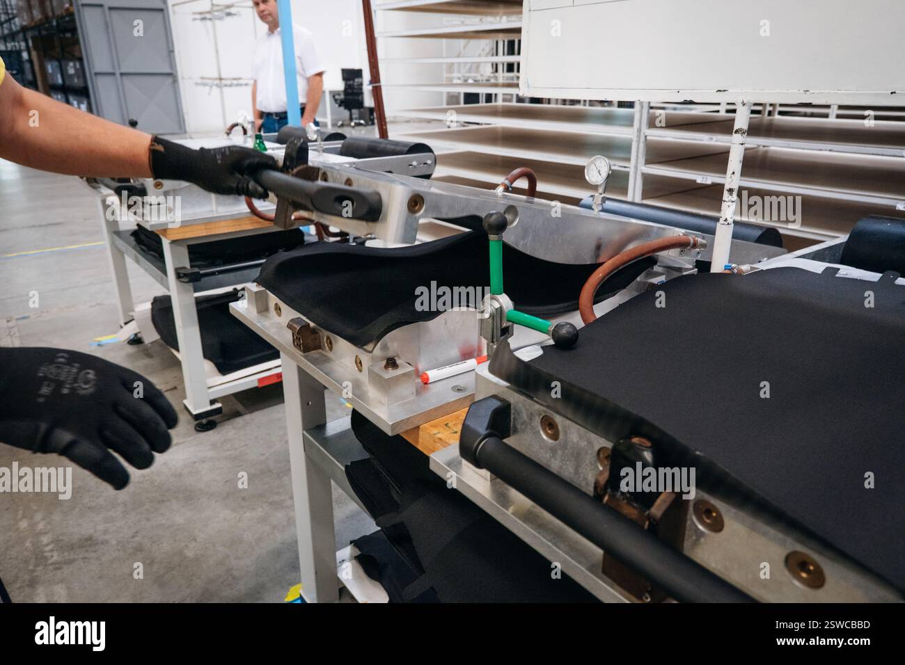 Workers using specialized equipment in an industrial setting focusing ...