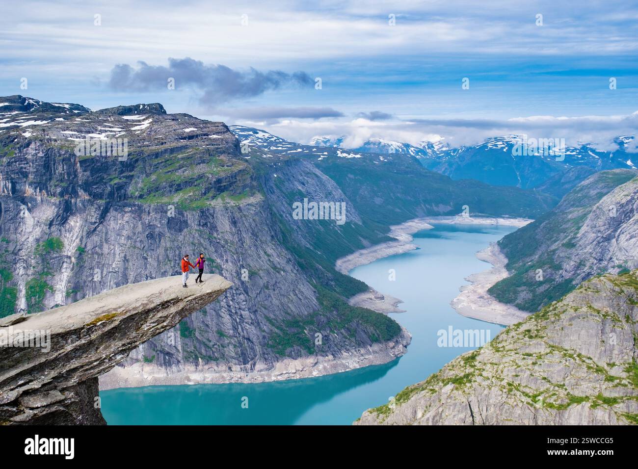 Overlooking the stunning blue of fjord couple of men women hi-res stock ...