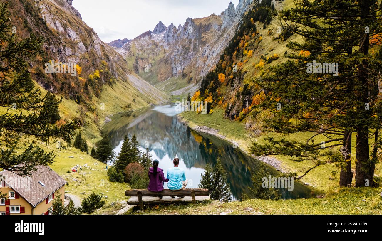 A couple sit on a bench, embracing the tranquility of Falensee. The ...