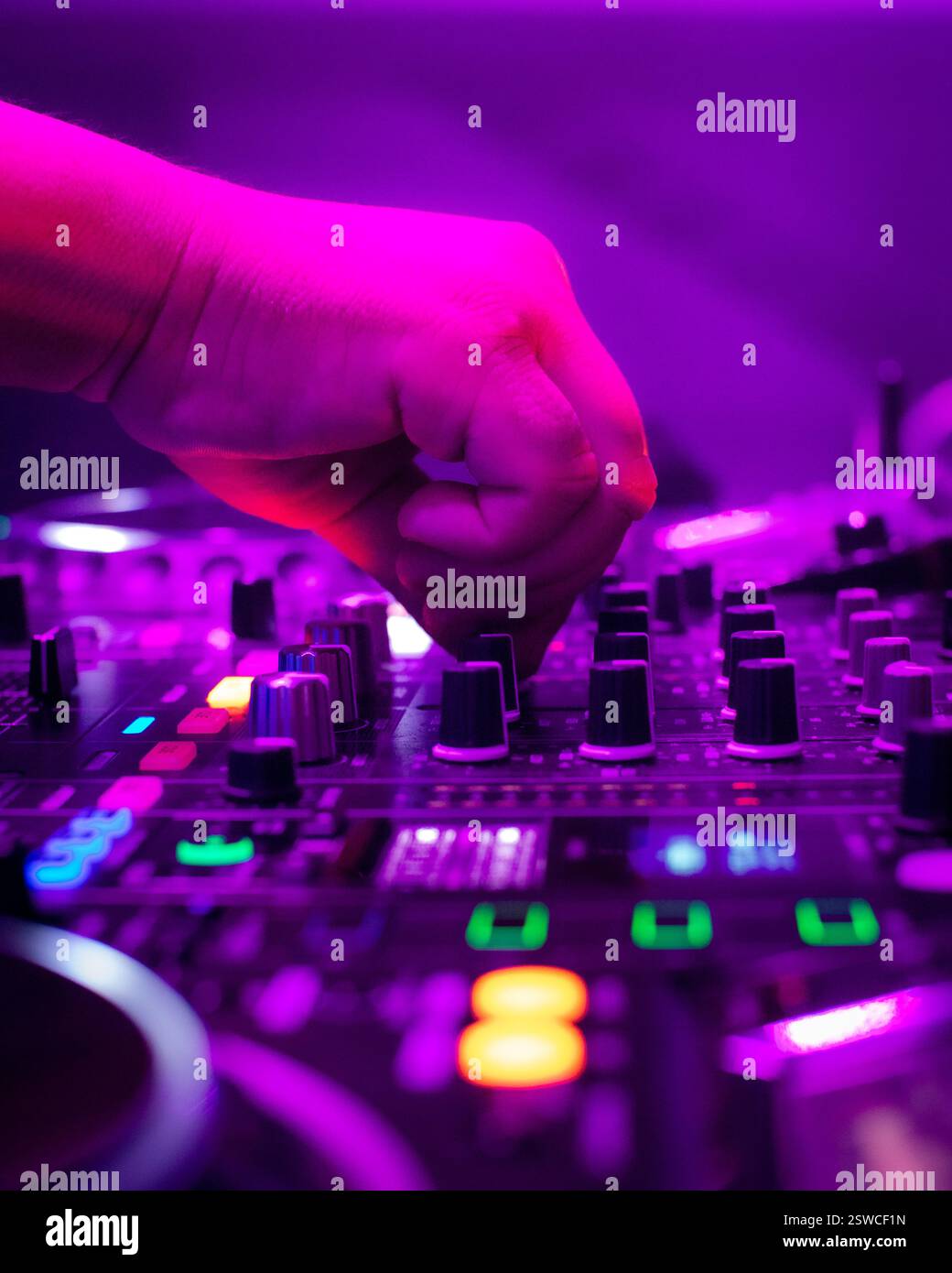A DJ mixing on a board in a club environment Stock Photo - Alamy