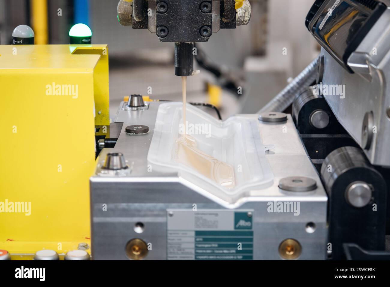 Industrial adhesive dispensing machine applying sealant to component ...