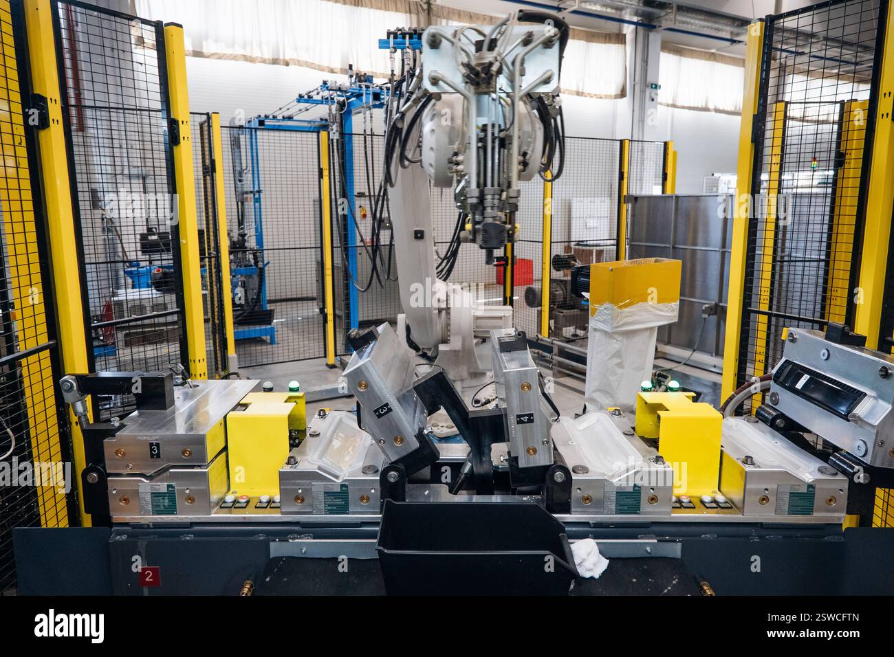 Automated robotic arm working on an assembly line in a factory ...