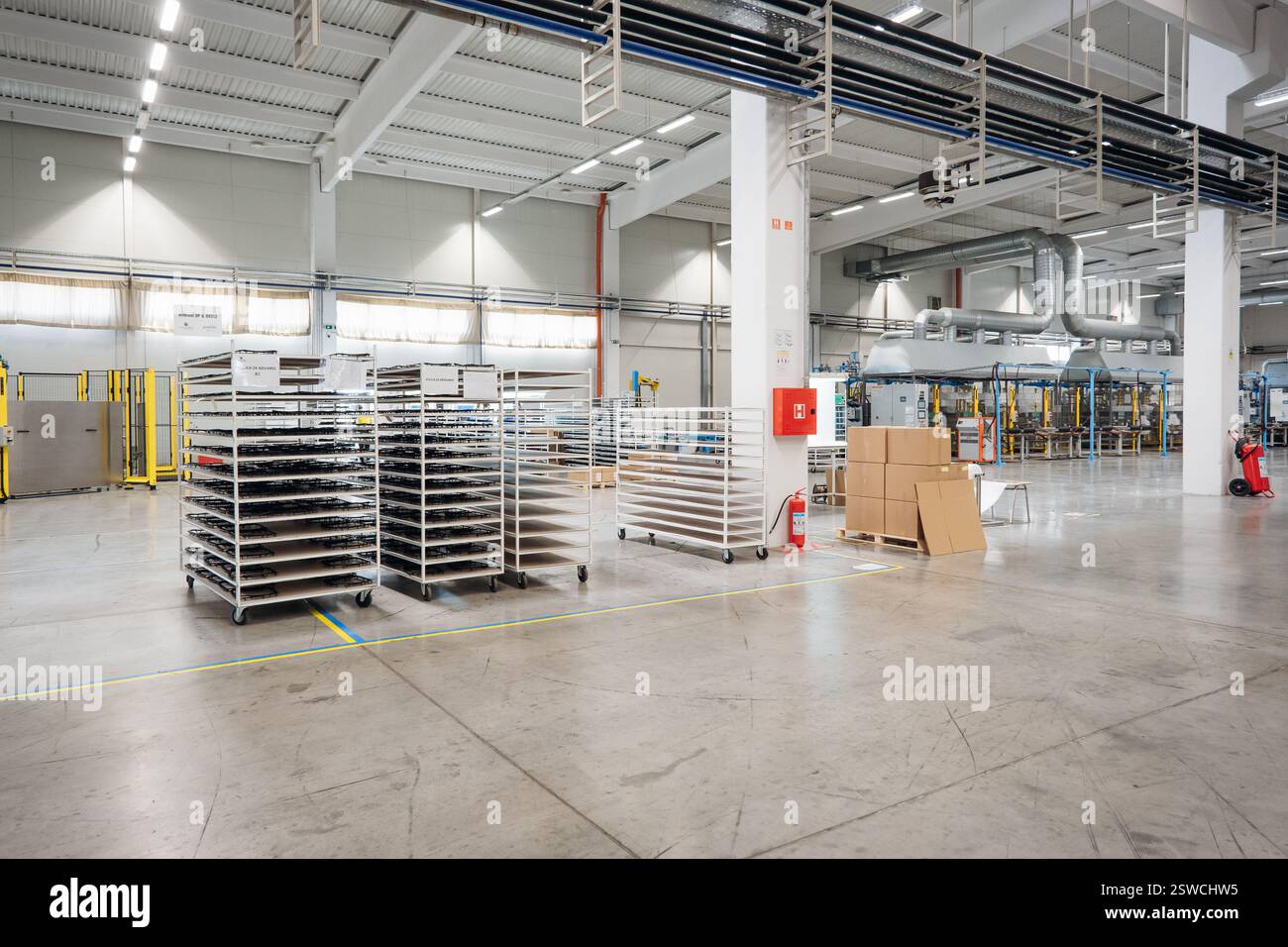 Spacious factory interior with equipment shelves and boxes showcasing ...