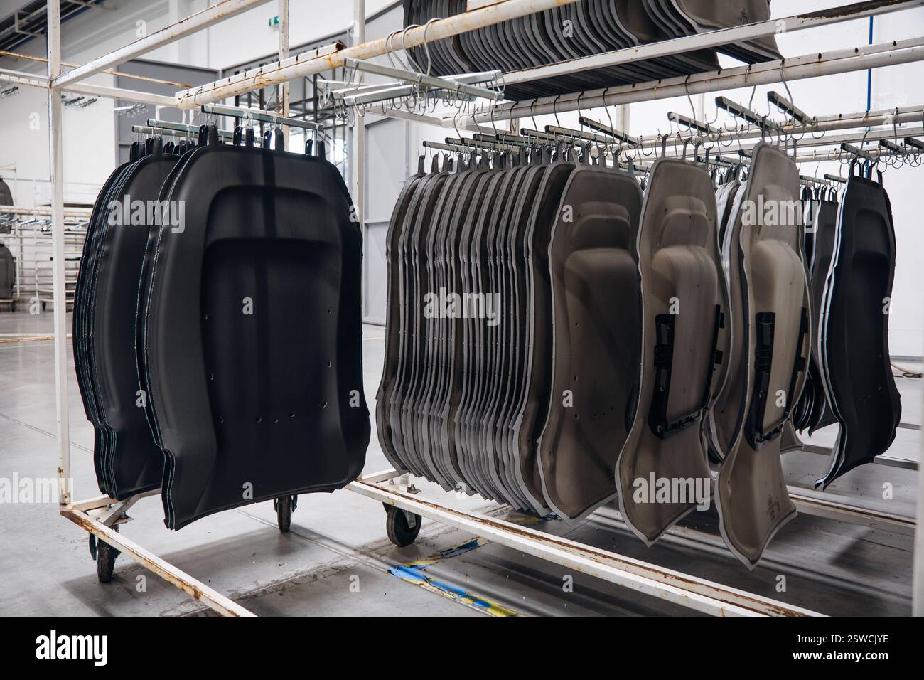 Automotive parts on a rack in a factory featuring clean lines and ...