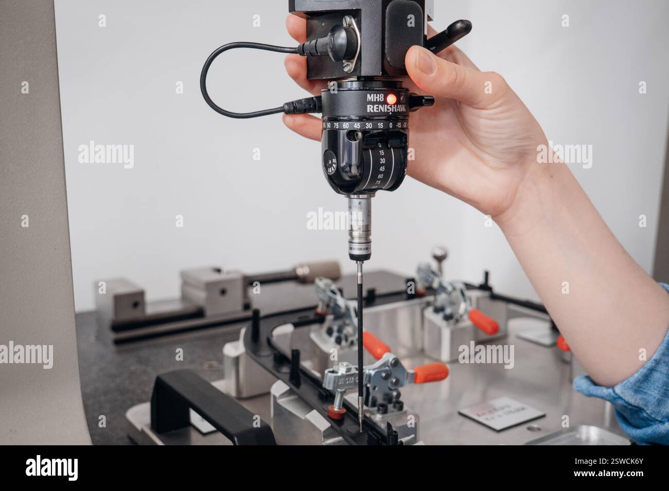 Precision engineering: A coordinate measuring machine probe analyzes a ...
