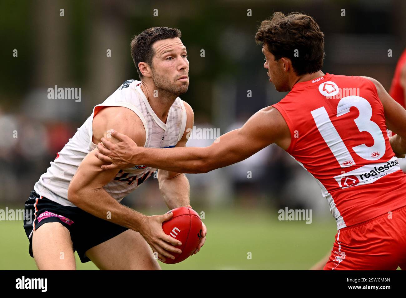 Toby Greene of the Giants competes for possession with Oliver Florent ...