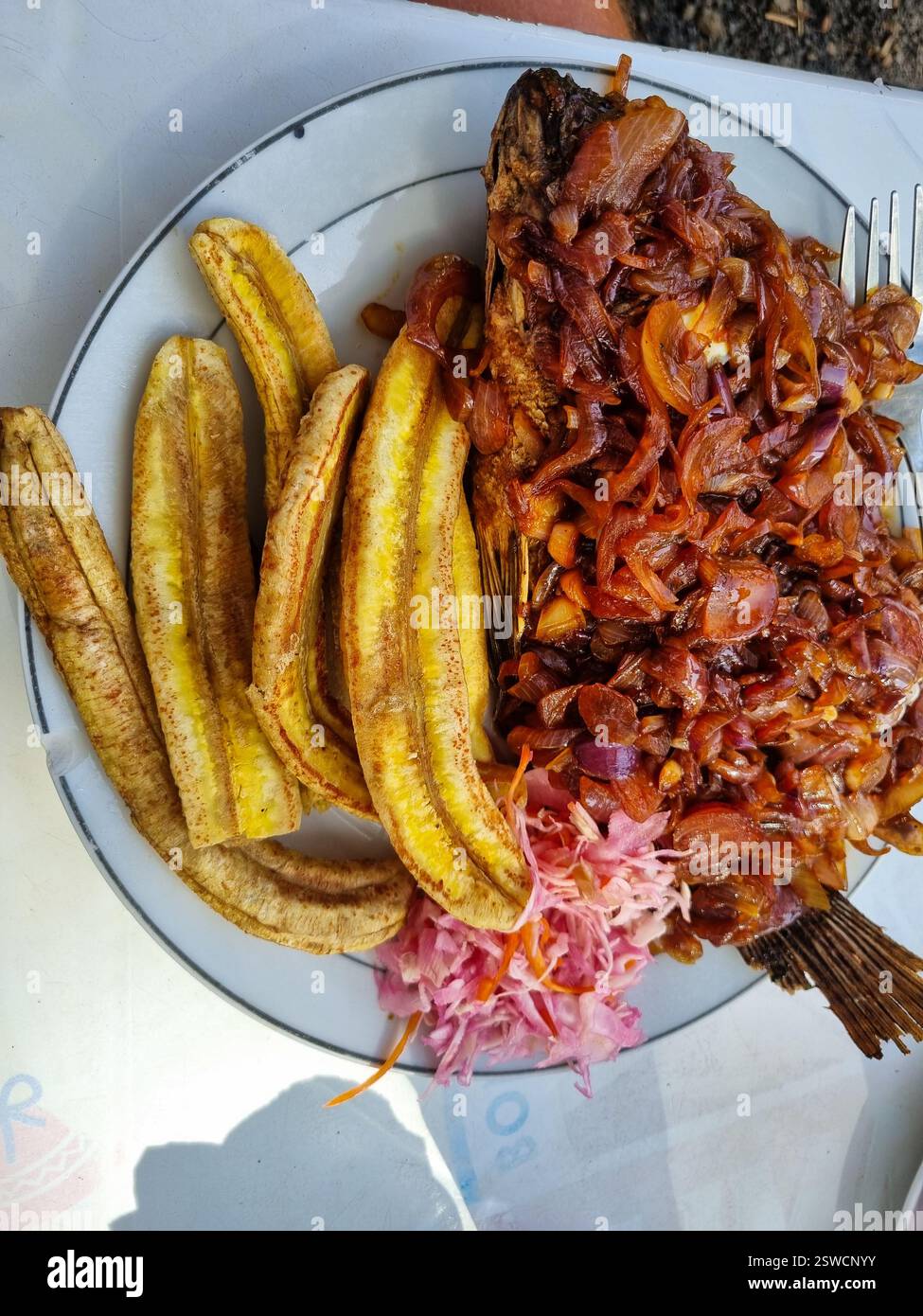 A Tanzania African dish featuring fried plantains and fish, made with ...