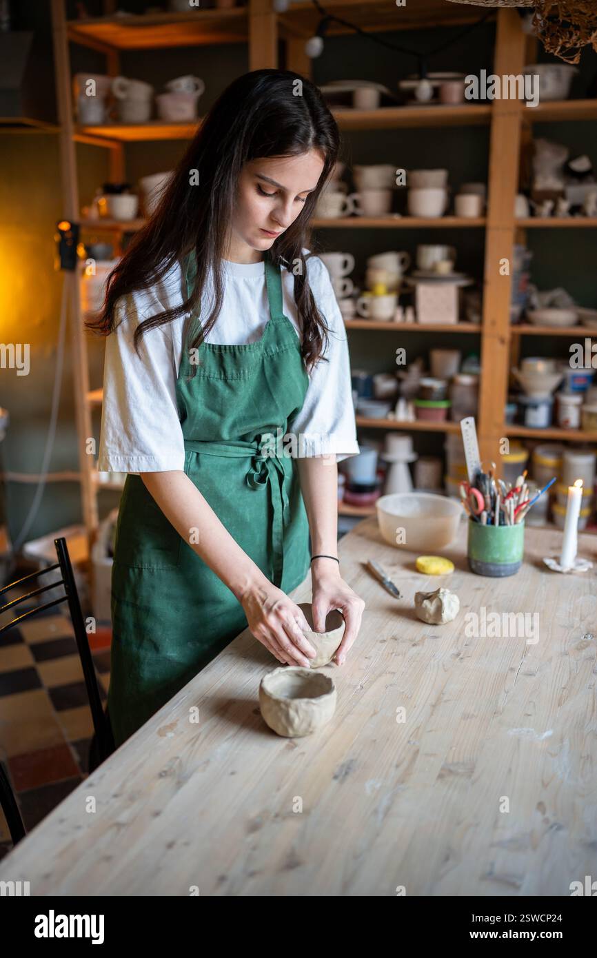 Creating handicraft pottery. Working table in ceramics studio with ...