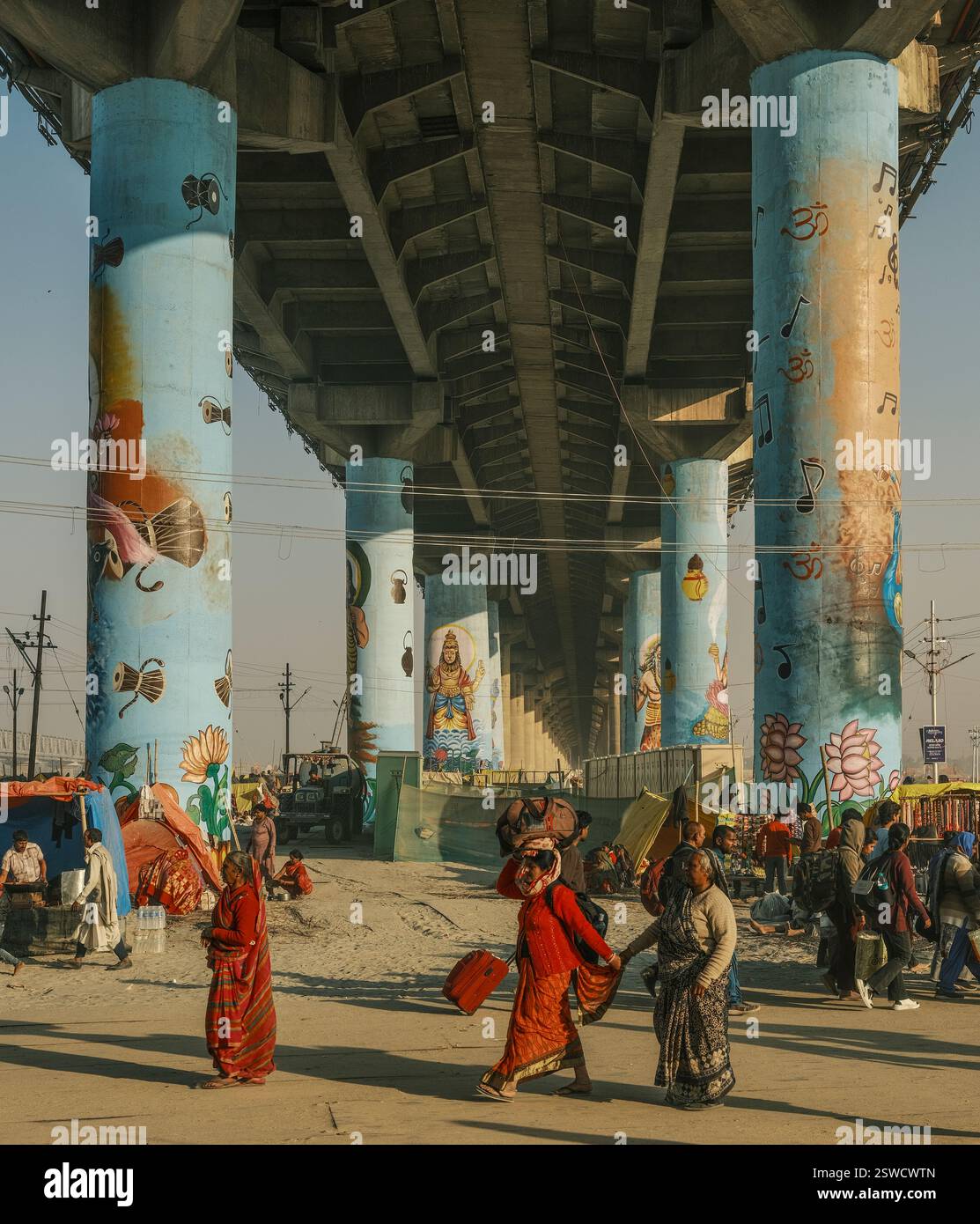 Under the vibrant pillars of the bridge during Maha Kumbh Mela in ...