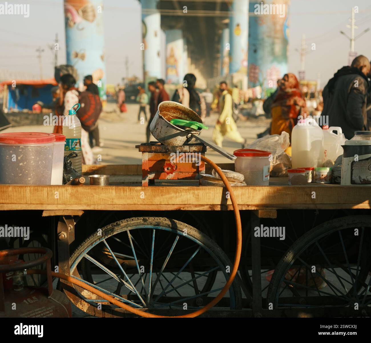 A close-up of a street food cart serving Indian tea, or masala chai, at ...