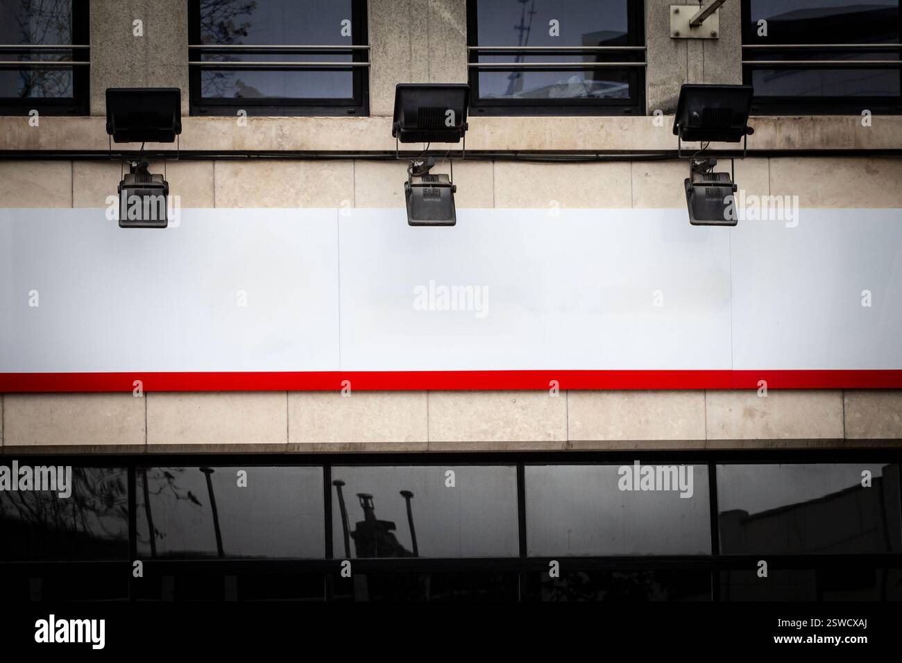 An empty horizontal white rectangular sign on an office facade in ...