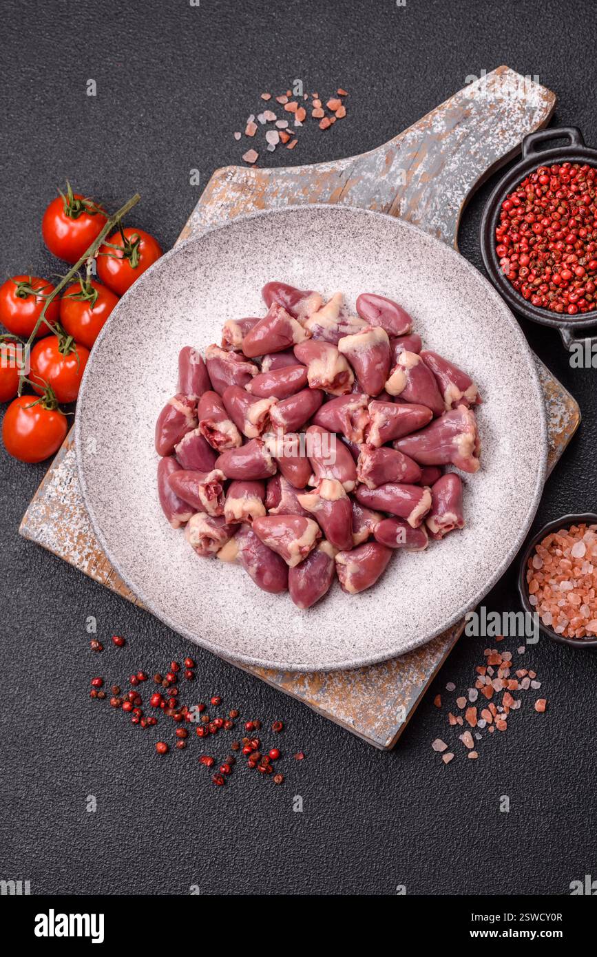 Raw chicken hearts with salt, spices and herbs Stock Photo - Alamy