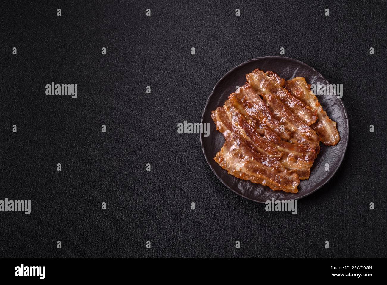 Crispy fried pork bacon sliced with salt, spices and herbs Stock Photo ...