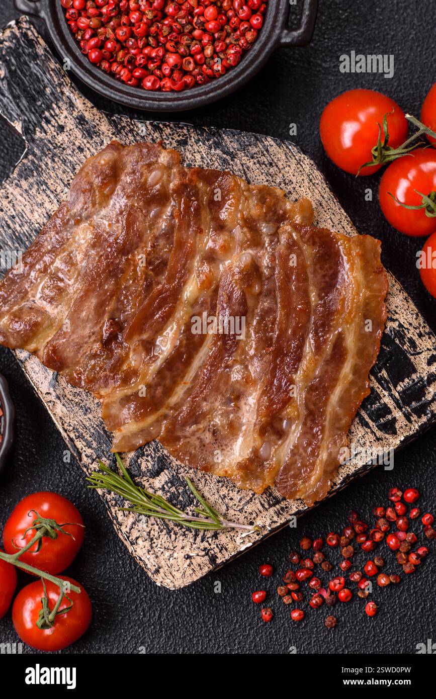 Crispy fried pork bacon sliced with salt, spices and herbs Stock Photo ...