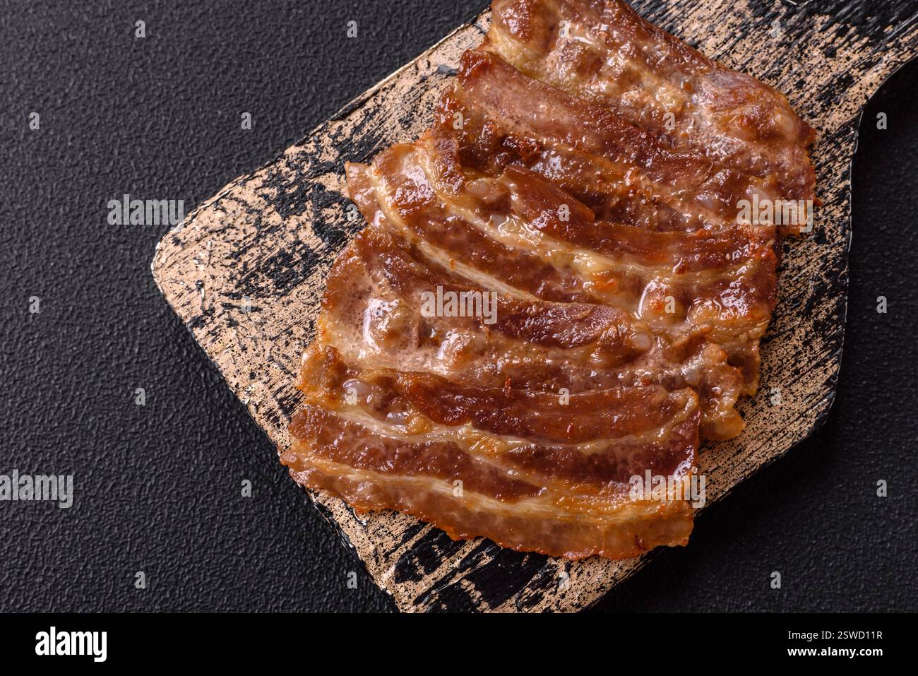 Crispy fried pork bacon sliced with salt, spices and herbs Stock Photo ...