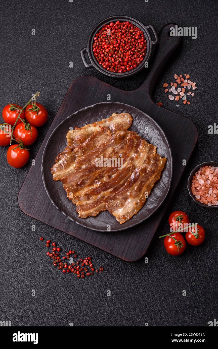 Crispy fried pork bacon sliced with salt, spices and herbs Stock Photo ...
