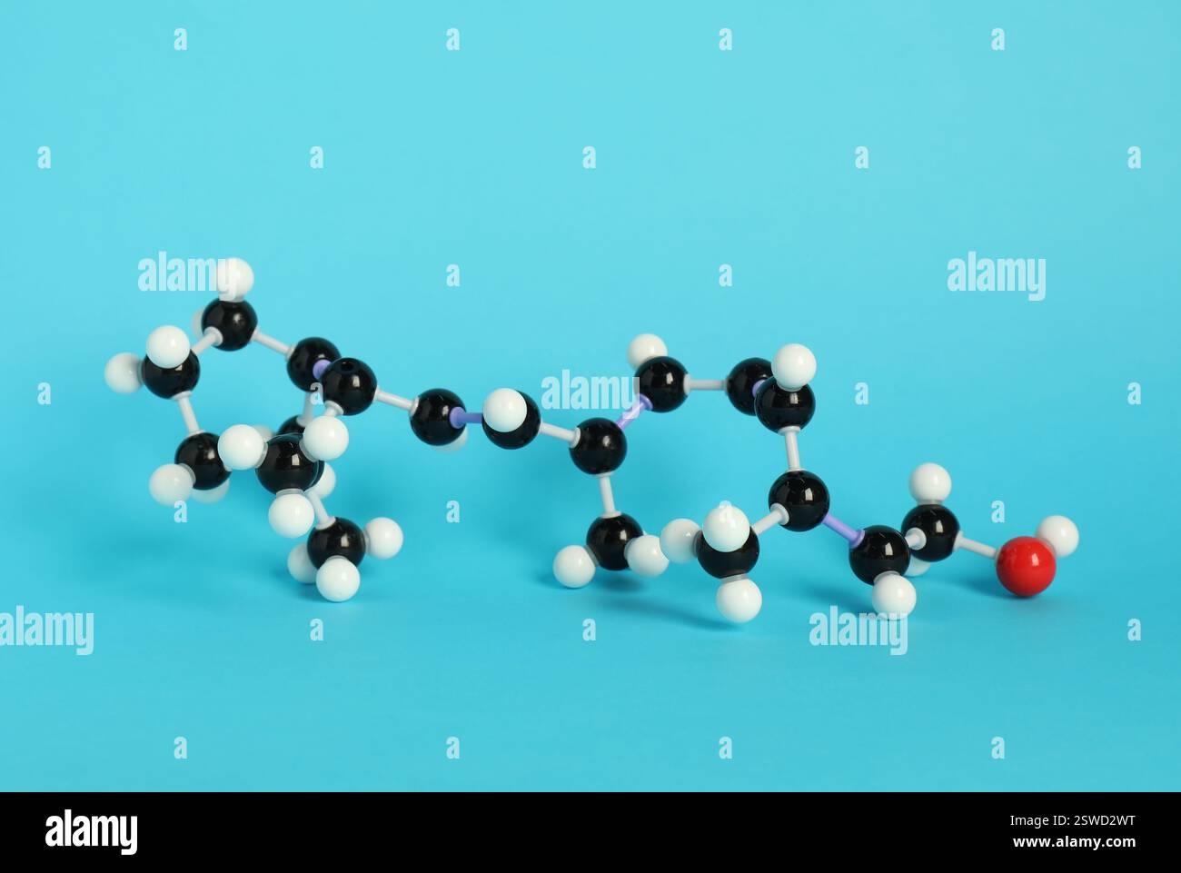 Molecule of retinol (vitamin A) on light blue background. Chemical ...