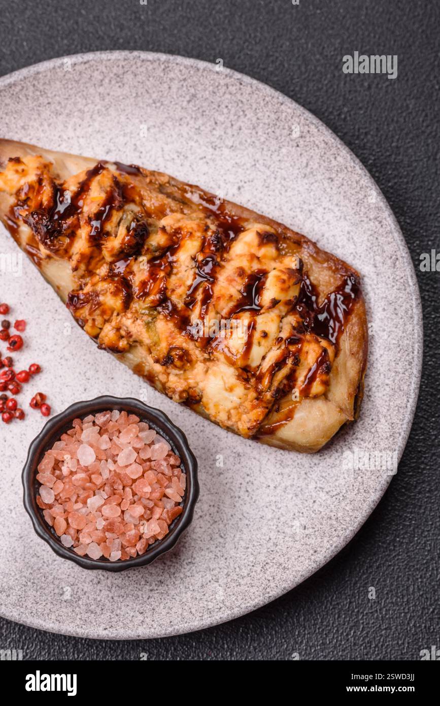 Grilled mackerel fillets with cheese, salt, spices and herbs on dark ...