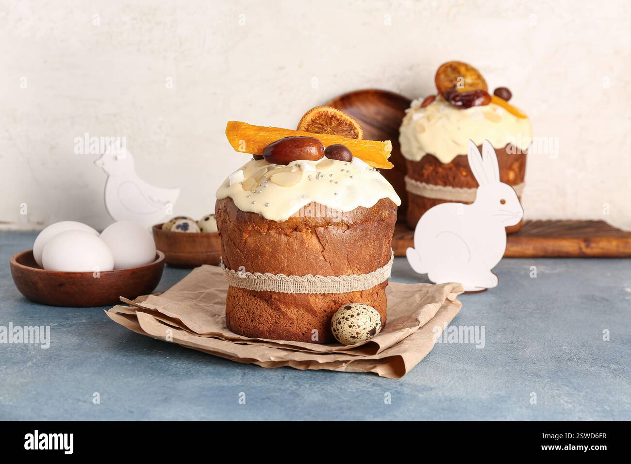 Easter cakes with animal figures and eggs on blue grunge table near ...