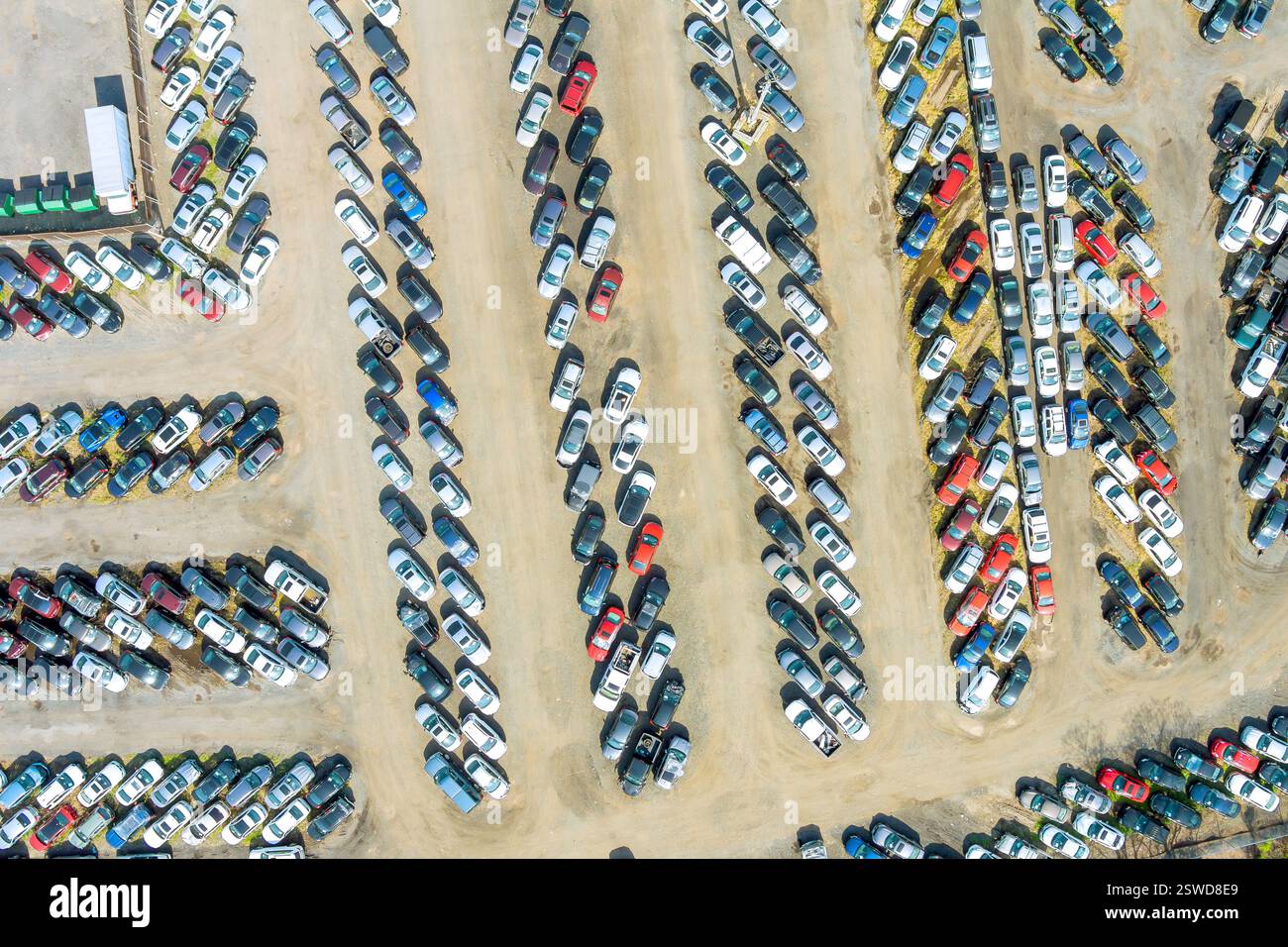 Vast lot of abandoned cars in different conditions stretches across an ...