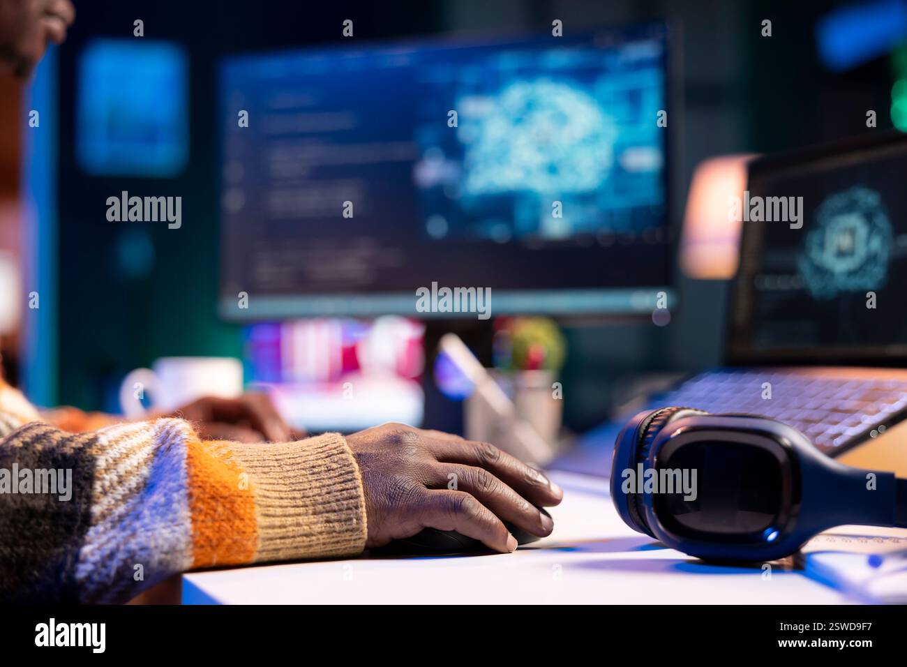 Black man programmer manages code and scripts in artificial intelligence and machine learning on ...