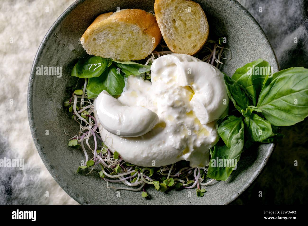 Traditional italian burrata knotted cheese in bowl Stock Photo - Alamy