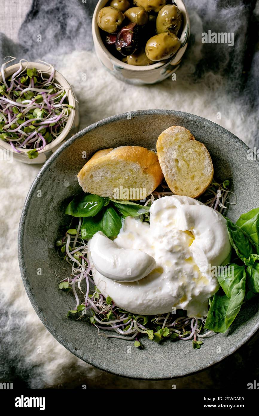 Traditional italian burrata knotted cheese in bowl Stock Photo - Alamy