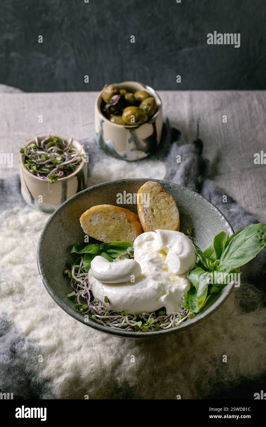 Traditional italian burrata knotted cheese in bowl Stock Photo - Alamy